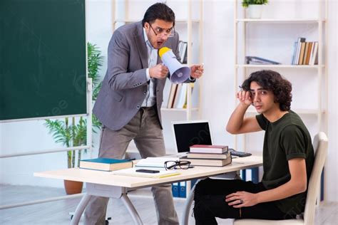 Young Teacher And Student In The Classroom Photo Background And Picture