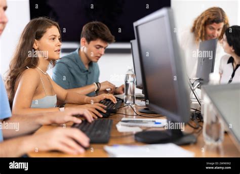 Female Student Of Computer Courses Attentively Looks At Monitor Screen