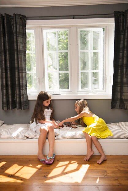 Premium Photo Two Girls Playing Together Indoors