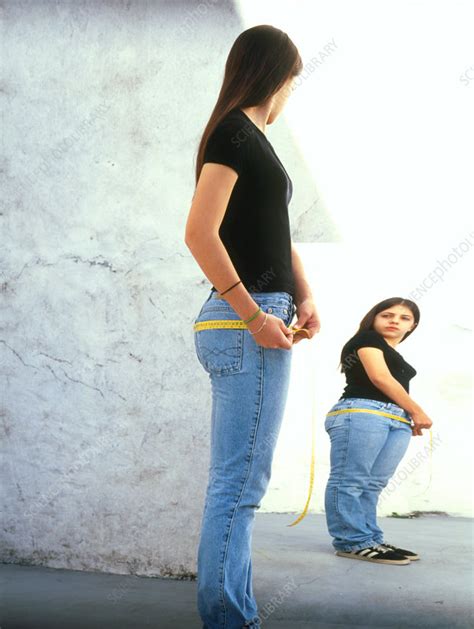Anorexic Teenage Girl Measuring Herself In Mirror Stock Image M245