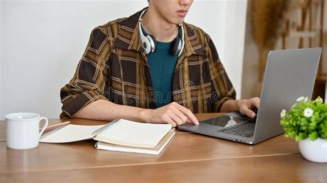 A Smart Young Asian Man Programmer Or Tech Engineer Using Laptop