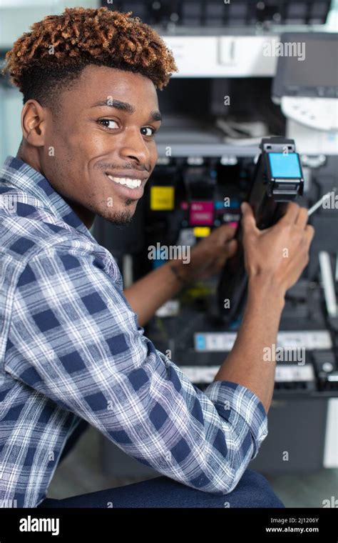 Worker Holds Ink Cartridge To Put Into Printer Stock Photo Alamy