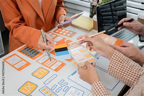 Creative Team Collaborates On Ux Ui Design Concepts With Wireframes And Prototypes In Modern