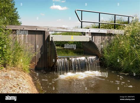 Small Overflow Dam In A River For Controling Water Level In A Nature