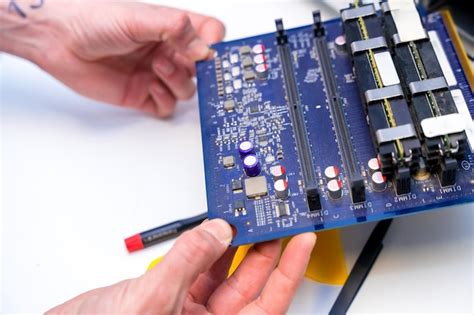 Premium Photo Technician Holding An Electronic Component Of Computer In A Workshop