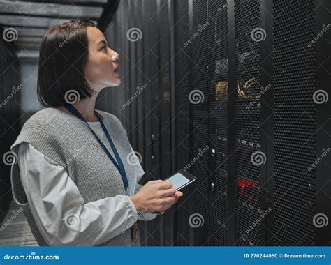 Tablet Server Room And Big Data With A Programmer Asian Woman At Work On A Computer Mainframe