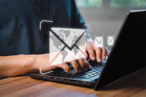 mans hand using computer laptop and sending online message with email