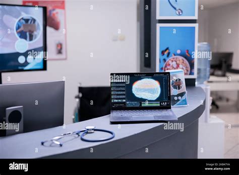 Brain Scan Displayed On Laptop Screen On Doctor Office Desk Computerized Tomography Images
