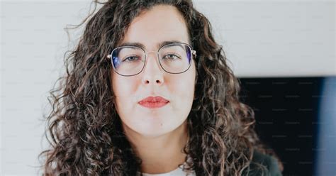 안경을 쓴 여자가 팔짱을 끼고 서 있다 사진 Unsplash의 장 이미지