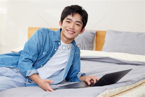 Babe Man Using Computer And Mobile Phone On Bed Picture And HD Photos Free Download On Lovepik