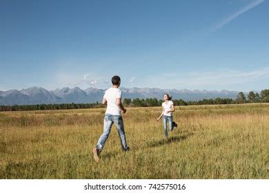 Couple Running Towards Each Other