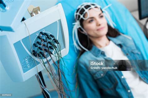 Close Up Of Electroencephalograph Recording Brain Waves Of Woman Stock