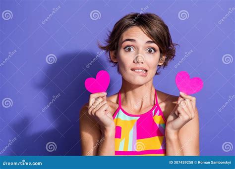 Photo Of Adorable Cute Girl Bite Lips In Colorful Clothes Showing Two