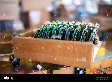 Green Control Chips Of Contemporary Tft Monitors In Small Cardboard Box In Assembling Workshop