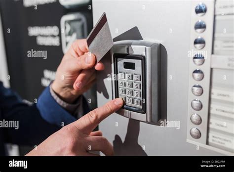 Man Scanning Security Key Card On Electric Lock And Entering Security System Code To Entry