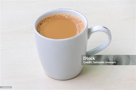 A Cup Of Hot Milk Tea Or Dudh Cha In A White Ceramic Cup On Light