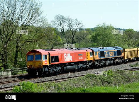 Two Gbrf Class 66 Diesel Locomotives Pulling A Freight Train
