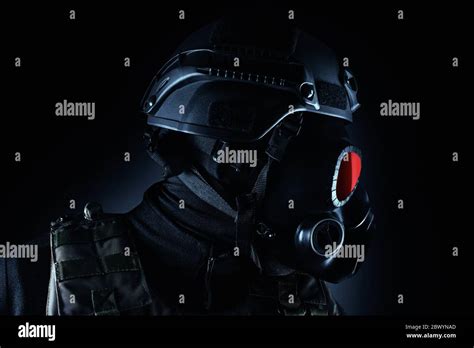 Photo Of A Fully Equipped Soldier In Black Armor Tactical Vest Gas
