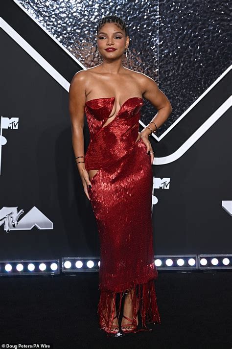 Halle Bailey Puts On A Busty Display In Scarlet Strapless Dress While