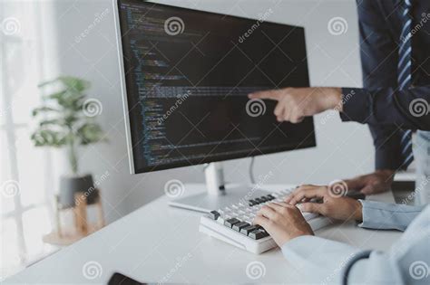 Two Programmers Looking At Computer Screen Programmer Design Custom Computer Programming