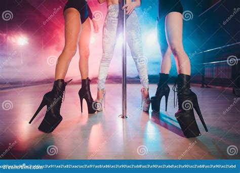 Young Striptease Dancers Moving In High Heels Shoes On Stage In Strip