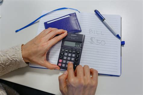 Upper View On Woman Hands Counting Expences On Calculator With Wallet
