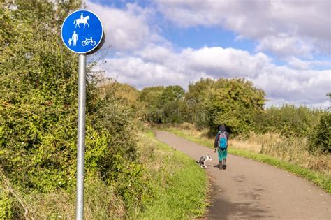 A Scenic Countryside Path With A Sign Indicating Permitted Uses For