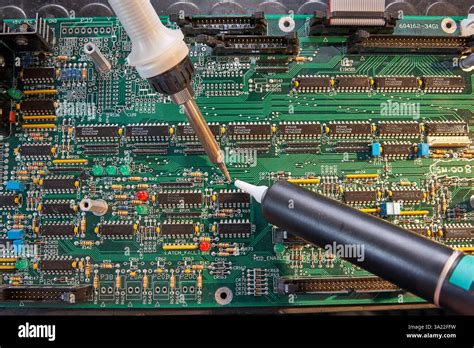 Electronics Repair Scene Featuring Circuit Board And Soldering Process