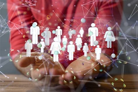person holding a floating digital render of people icons a global