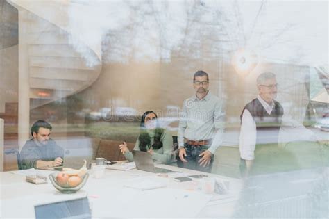A Multi Generational Team Of Employees Brainstorming And Collaborating