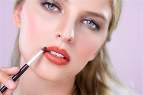 Closeup Beautiful Young Woman Putting Alluring Fashion Glossy Red