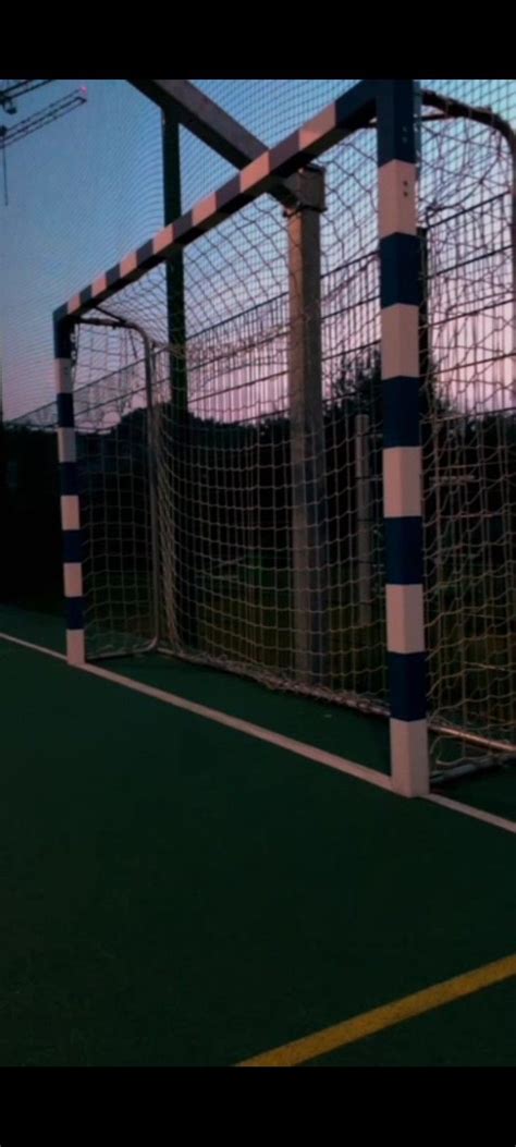 a man is playing tennis on the court at sunset or dawn, with his ...