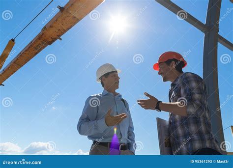 Builder And Business Man Discussing Project Meeting Outdoors On Buiding