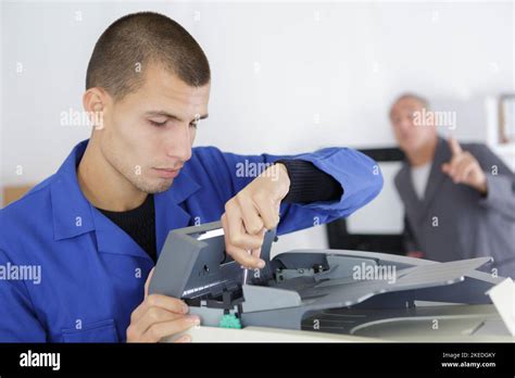 A Man Fixing A Printer Stock Photo Alamy