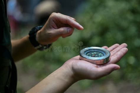 Close Up View Of Male Hiker Using Compass For Directions While Exploring Nature In The Forest