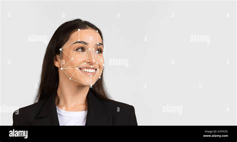 Smiling Woman With Facial Recognition Markers Showing Tech Use Stock