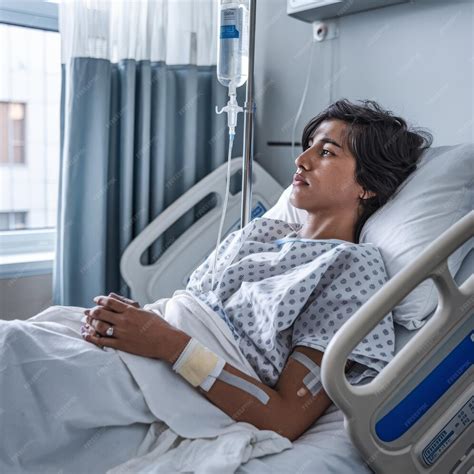 Thoughtful Sick Patient With Iv Drip Looking Away While Lying On