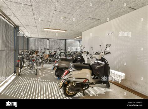 some motorcycles parked in a room with many bikes on the wall and one bike is leaning up against ...
