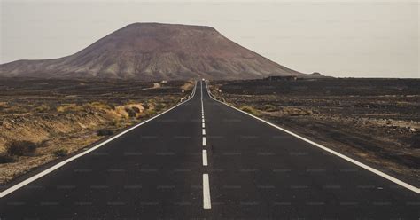 산과 계곡 봉우리 한가운데에 있는 먼 아스팔트 도로 휴가의 대체 장소에서 여행 및 목적지 개념에 대한 무한에 대한 흰색 선 사진 Unsplash의 아스팔트 도로 이미지