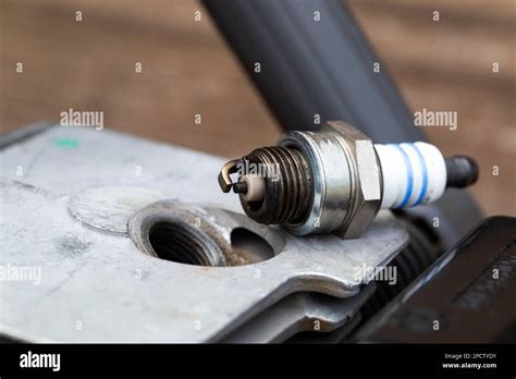 Spark Plug Unscrewed From The Cylinder Of The Combustion Chamber Of A Two Stroke Engine
