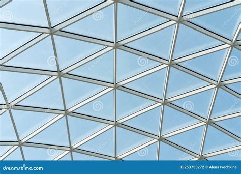 Architectural Glass Structure With A Geometric Triangular Pattern On A Blue Sky Background
