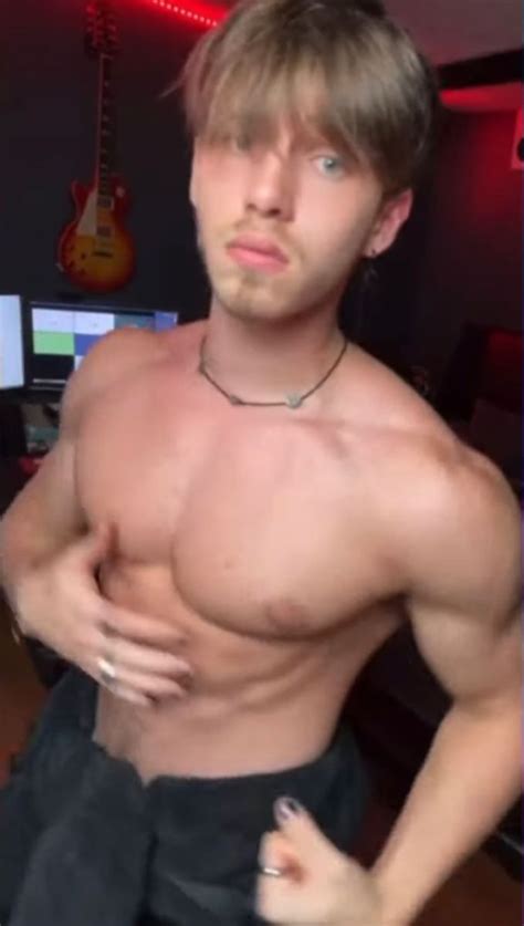 A Man With No Shirt On Posing For The Camera