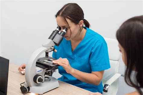 Premium Photo Woman Doctor Examines Through A Microscope Laboratory Research With A Microscope