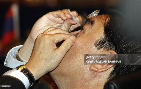 Secretary General Ong Keng Yong Puts An Eye Drop On His Eye Before News Photo Getty Images