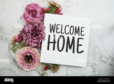 Welcome Home Text With Pink Flower Bouquet On Marble Background Stock