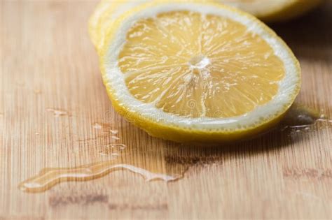 Cut Lemon Slices On A Wooden Board Close Up The Juice Is Flowing