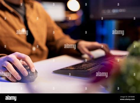 Man Doing Software Quality Assurance Using Keyboard And Mouse Reading Source Code On Computer