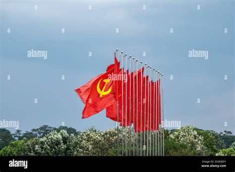 Large Communist Flag Floating In The Wind With A Blue Sky Background