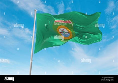 Official Flag Of South Sumatra Indonesia At Cloudy Sky Background On
