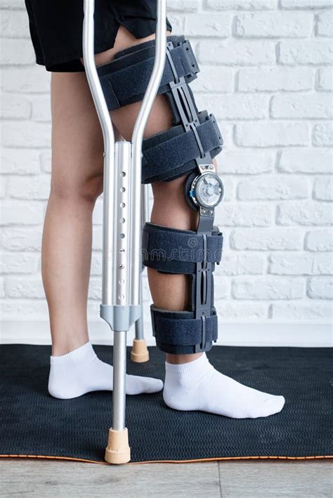 Female Wearing Knee Orthosis Or Knee Support Brace After Surgery On Leg